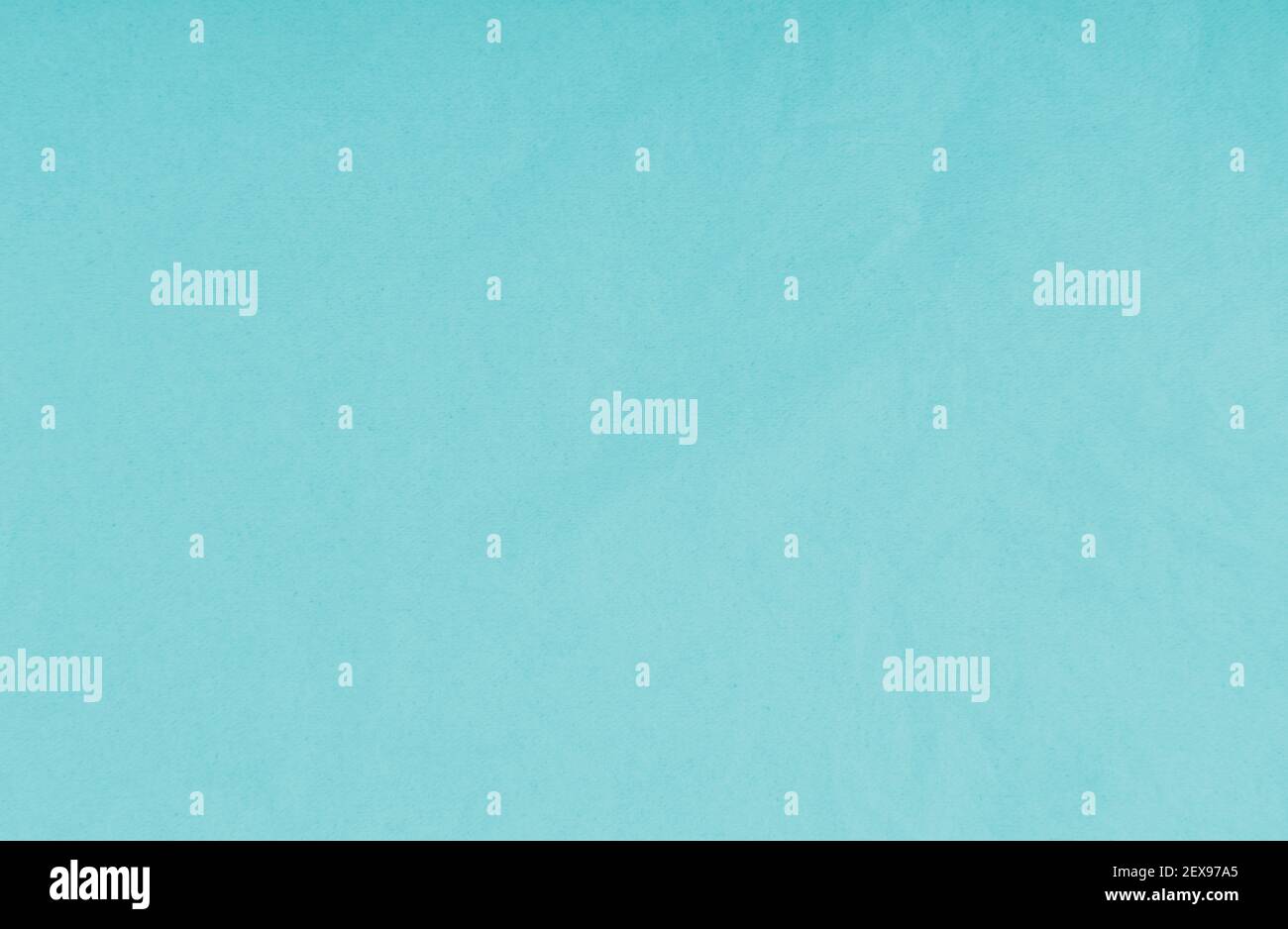 A rough-textured light blue grainy paper used as wallpaper or ...