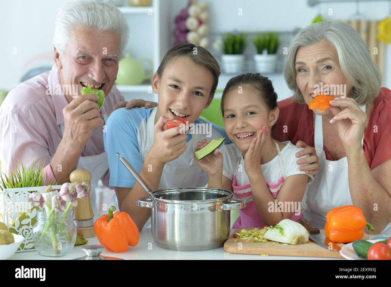 Portrait of family cooking together in kitchen Stock Photo - Alamy