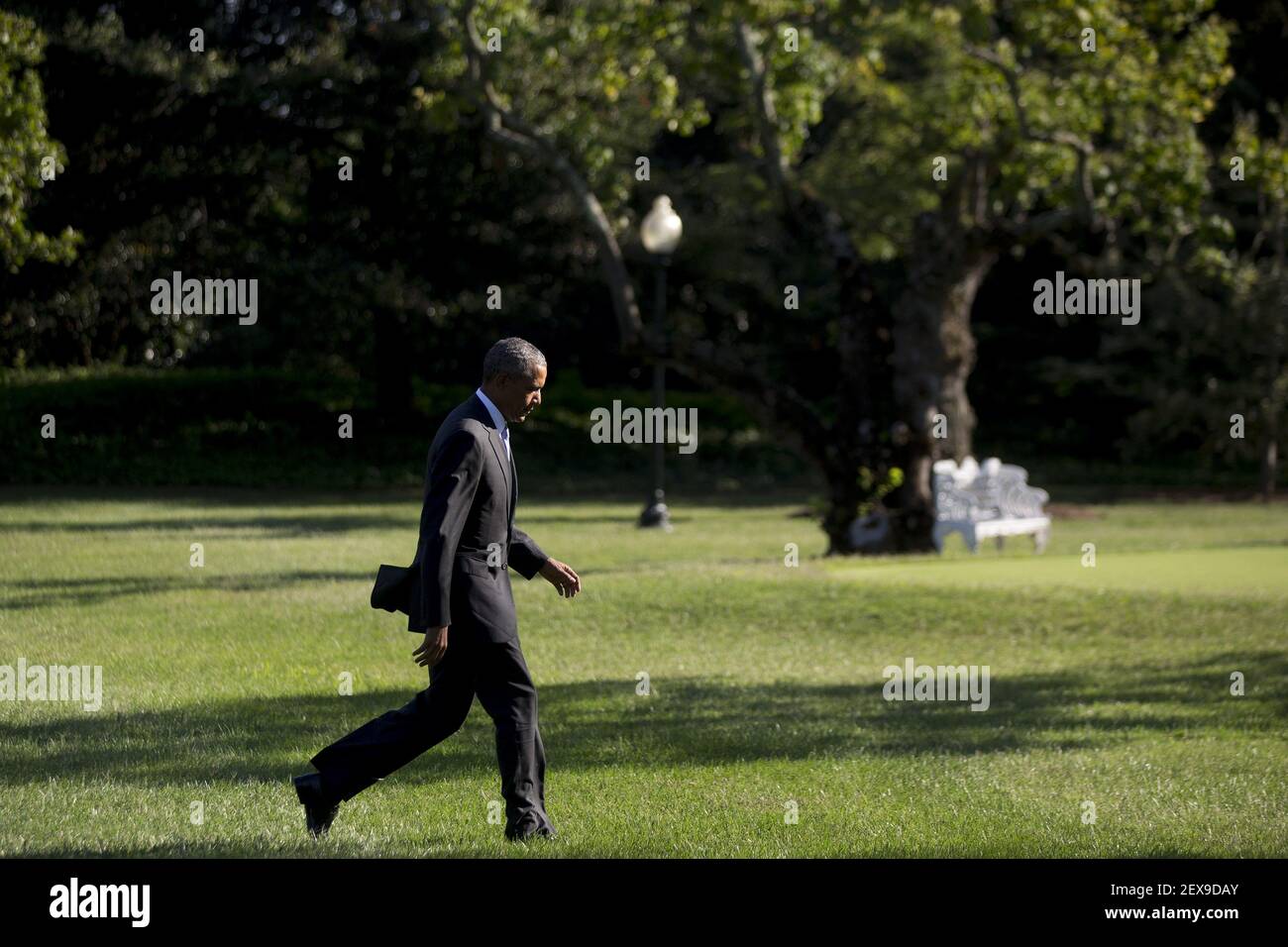 U.S. President Barack Obama walks toward the White House after landing ...