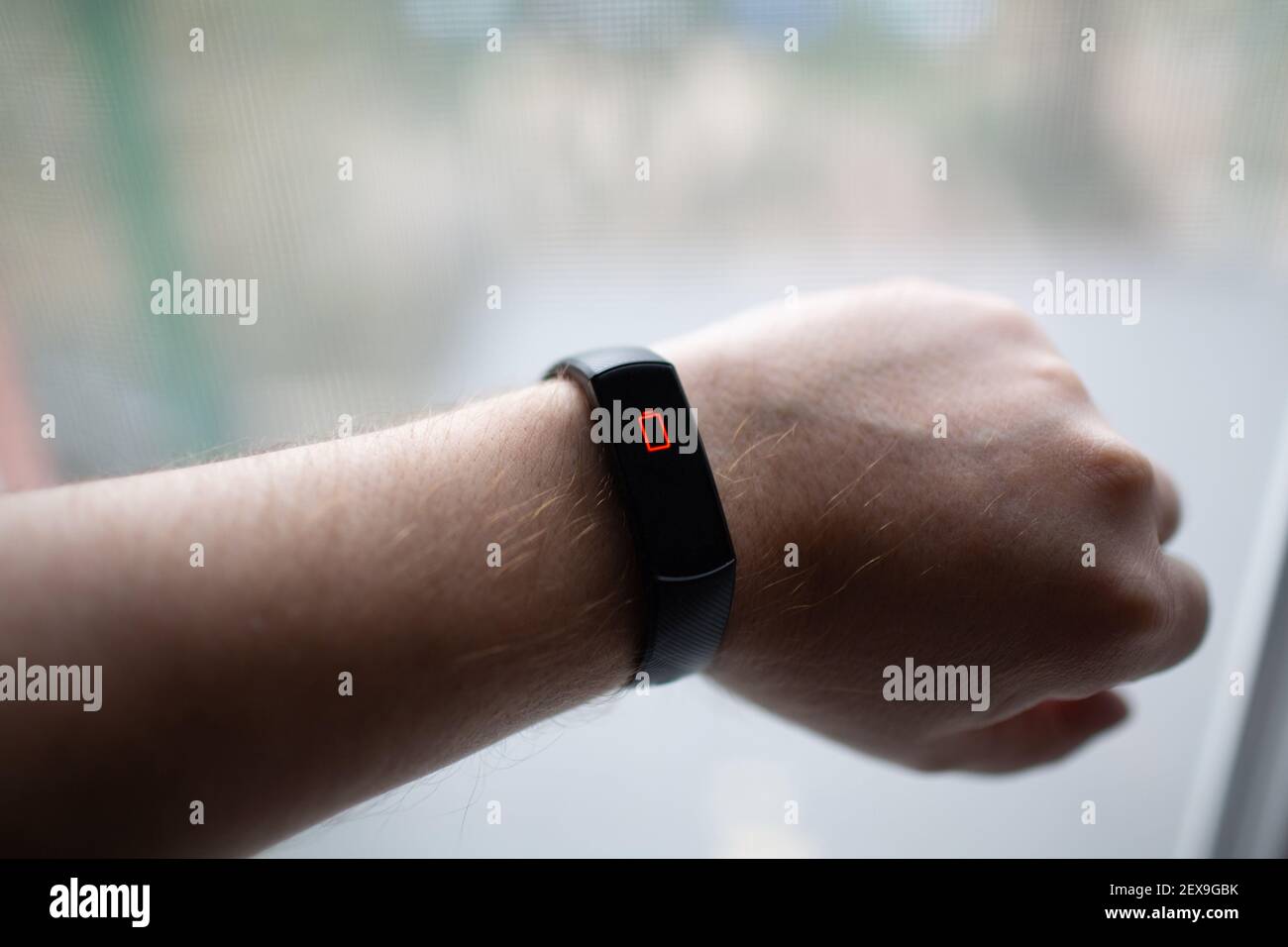 Male hand with fitness tracker with low charge battery symbol Stock ...