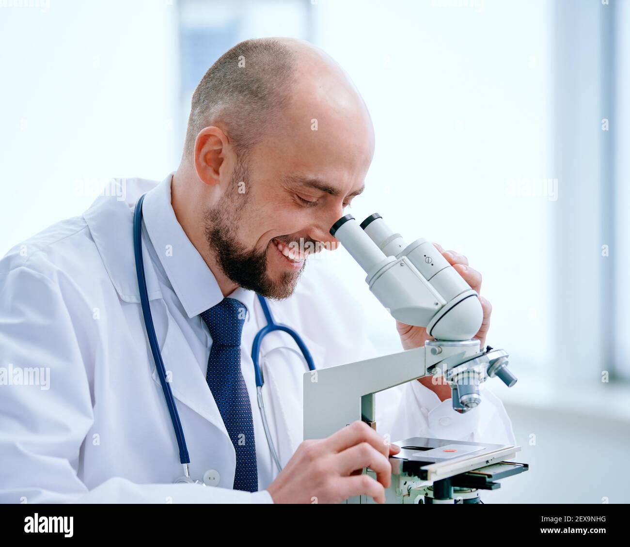 researcher looking through a microscope in a medical laboratory Stock ...