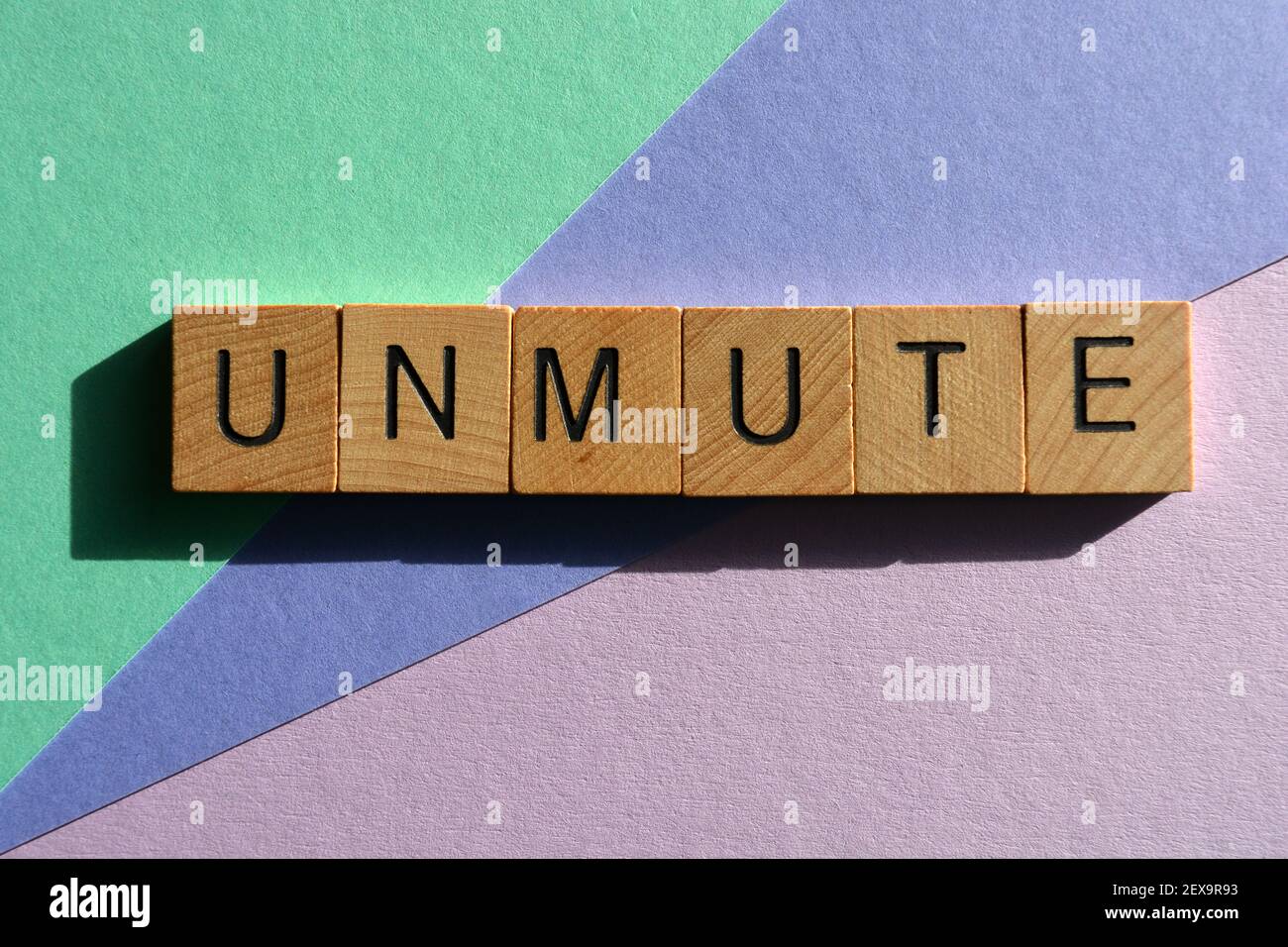 Unmute, word in wooden alphabet letters isolated on background as a ...