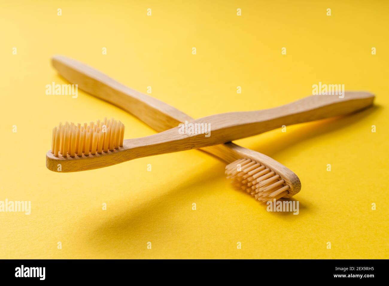Bamboo organic toothbrushes for dental hygiene on trendy yellow ...