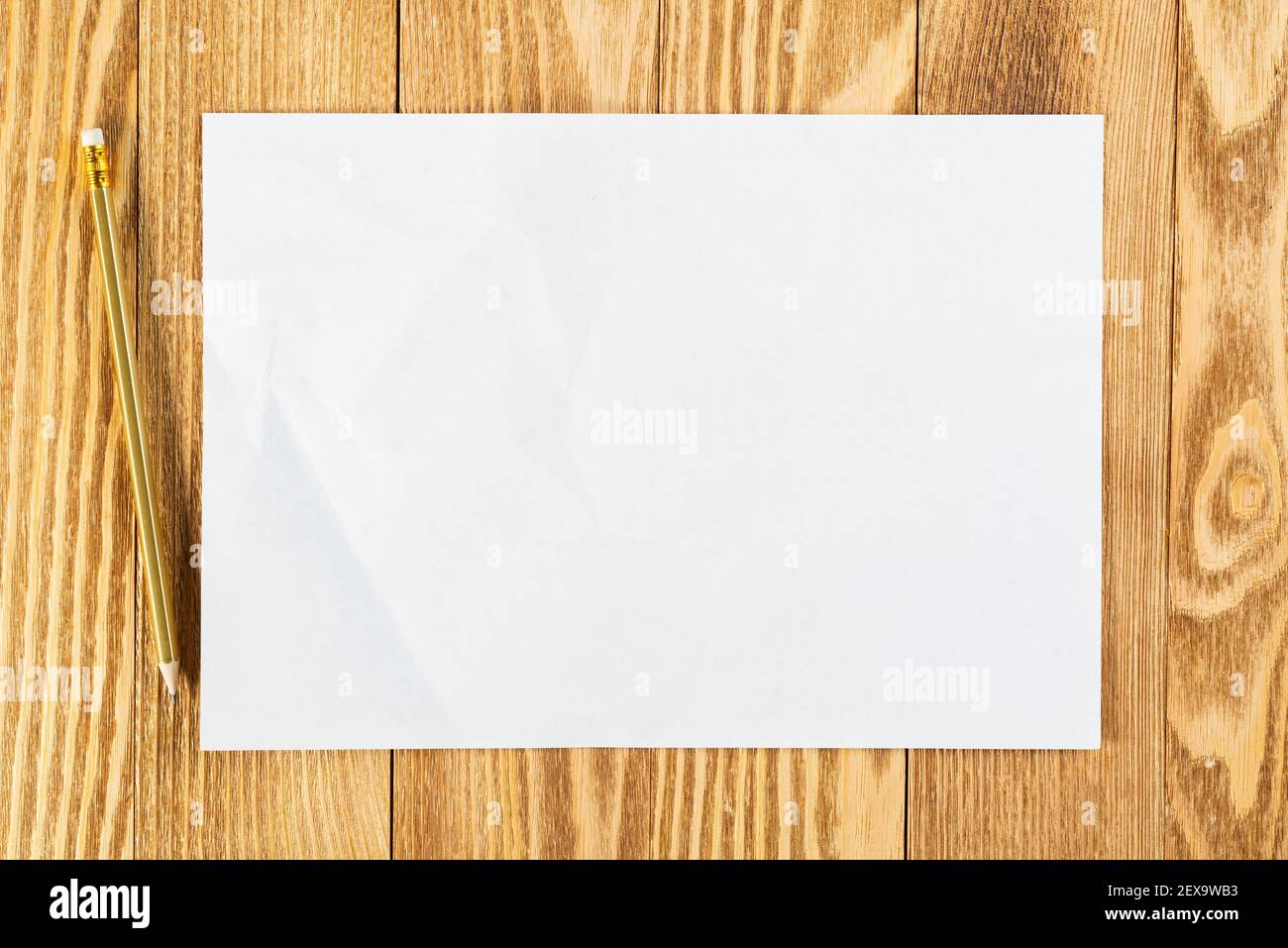Flat lay wooden table with paper sheet Stock Photo - Alamy