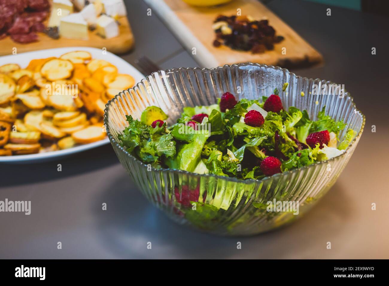 Set up table with salad and boards of appetizers Stock Photo - Alamy