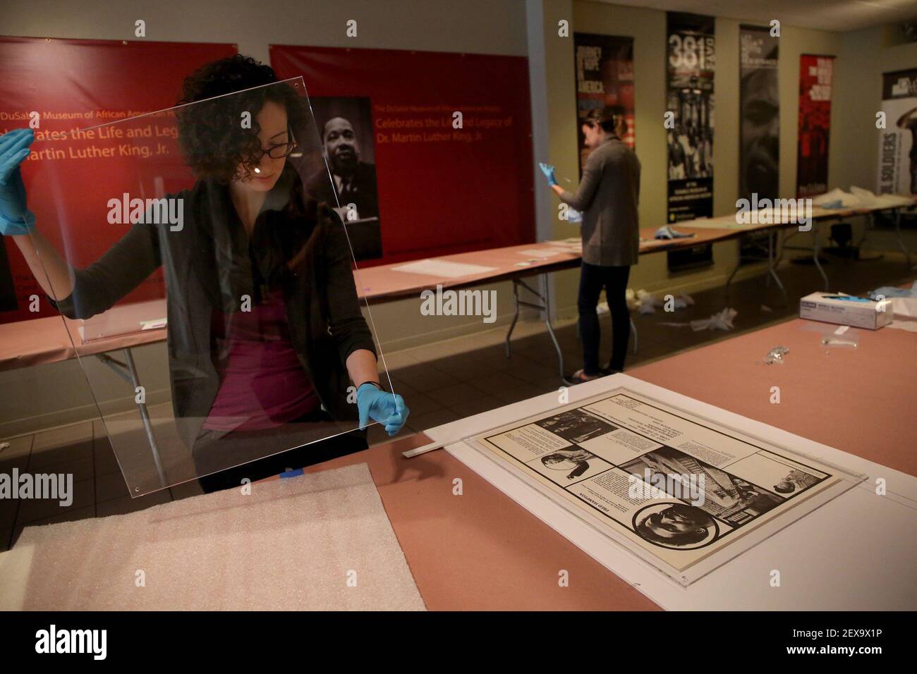 Kate Swisher, Registrar, frames a poster that urges people to protest ...
