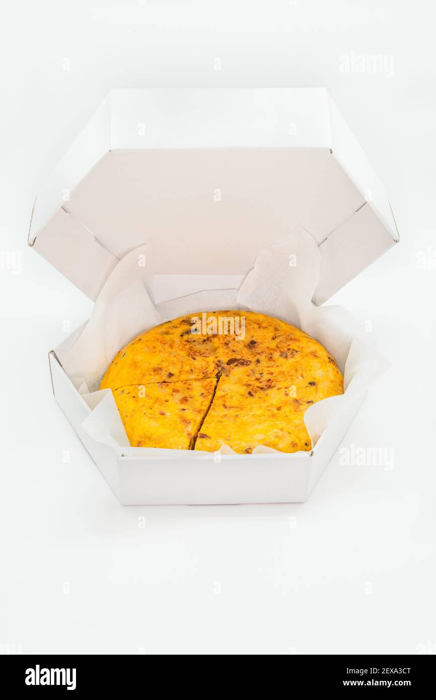 A vertical shot of a Spanish omelet inside a delivery packaging ...