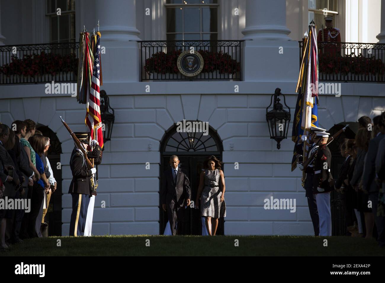 President Barack Obama and First Lady Michelle Obama walk onto the ...