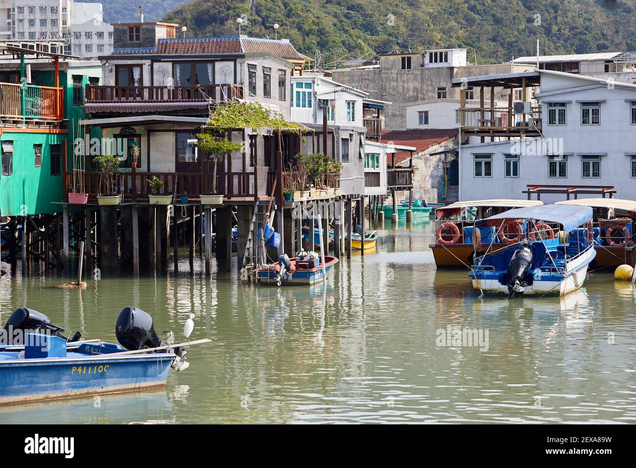 Boats and traditional stilt houses along the Tai O River in Tai O ...