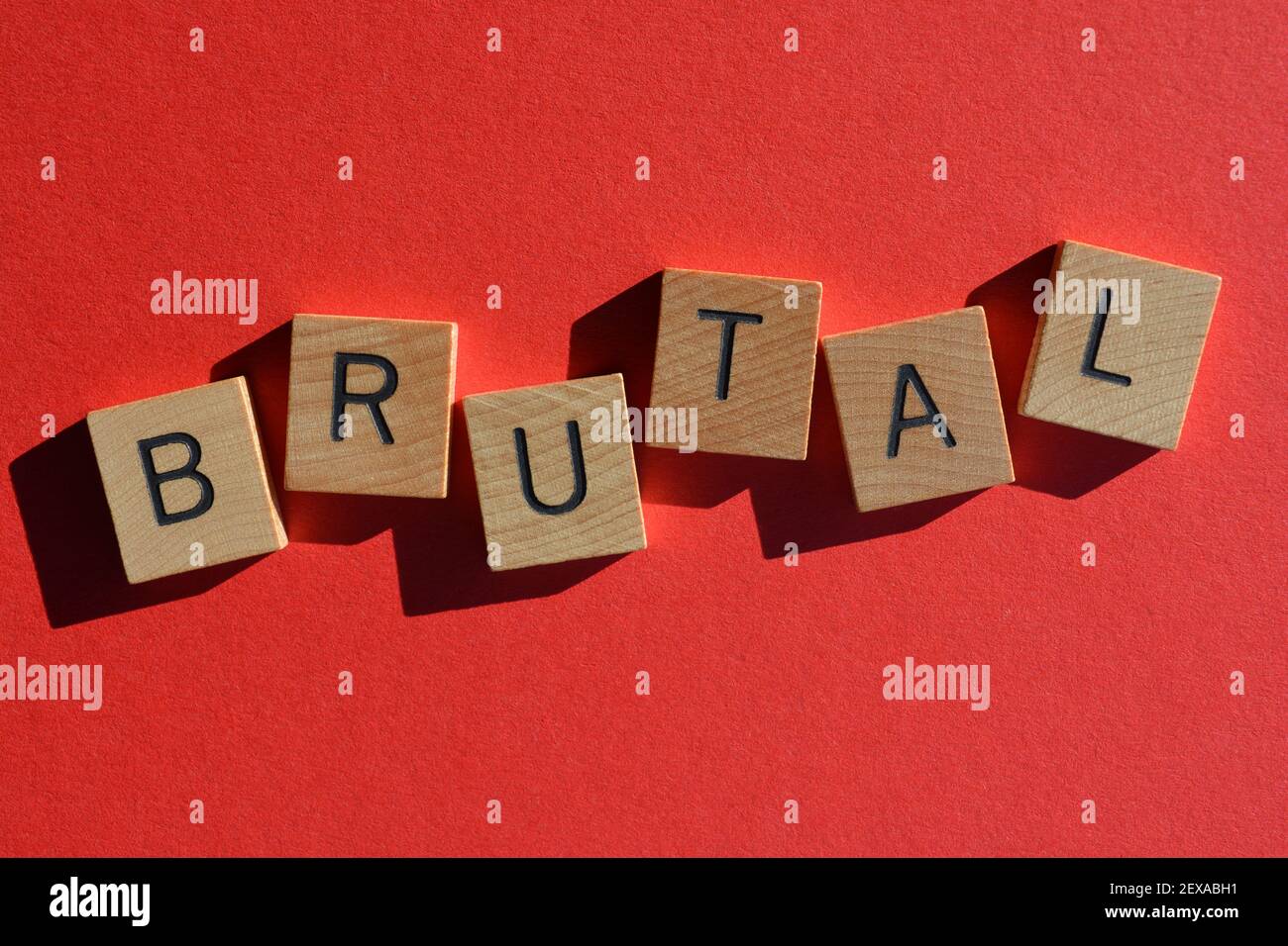 Brutal, word in wooden alphabet letters isolated on red background ...