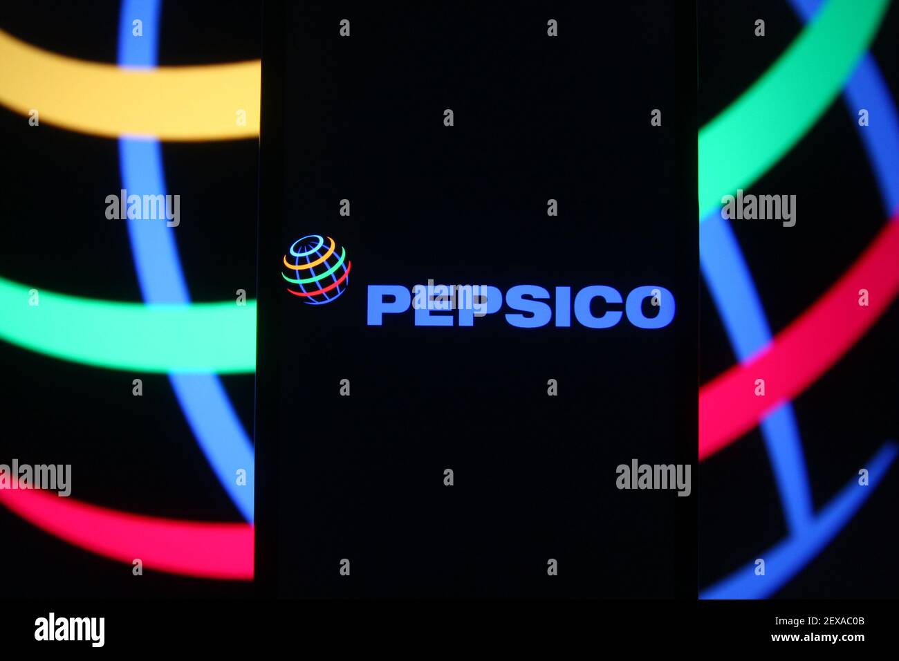 In this photo illustration a Pepsico logo is seen on a smartphone and a ...