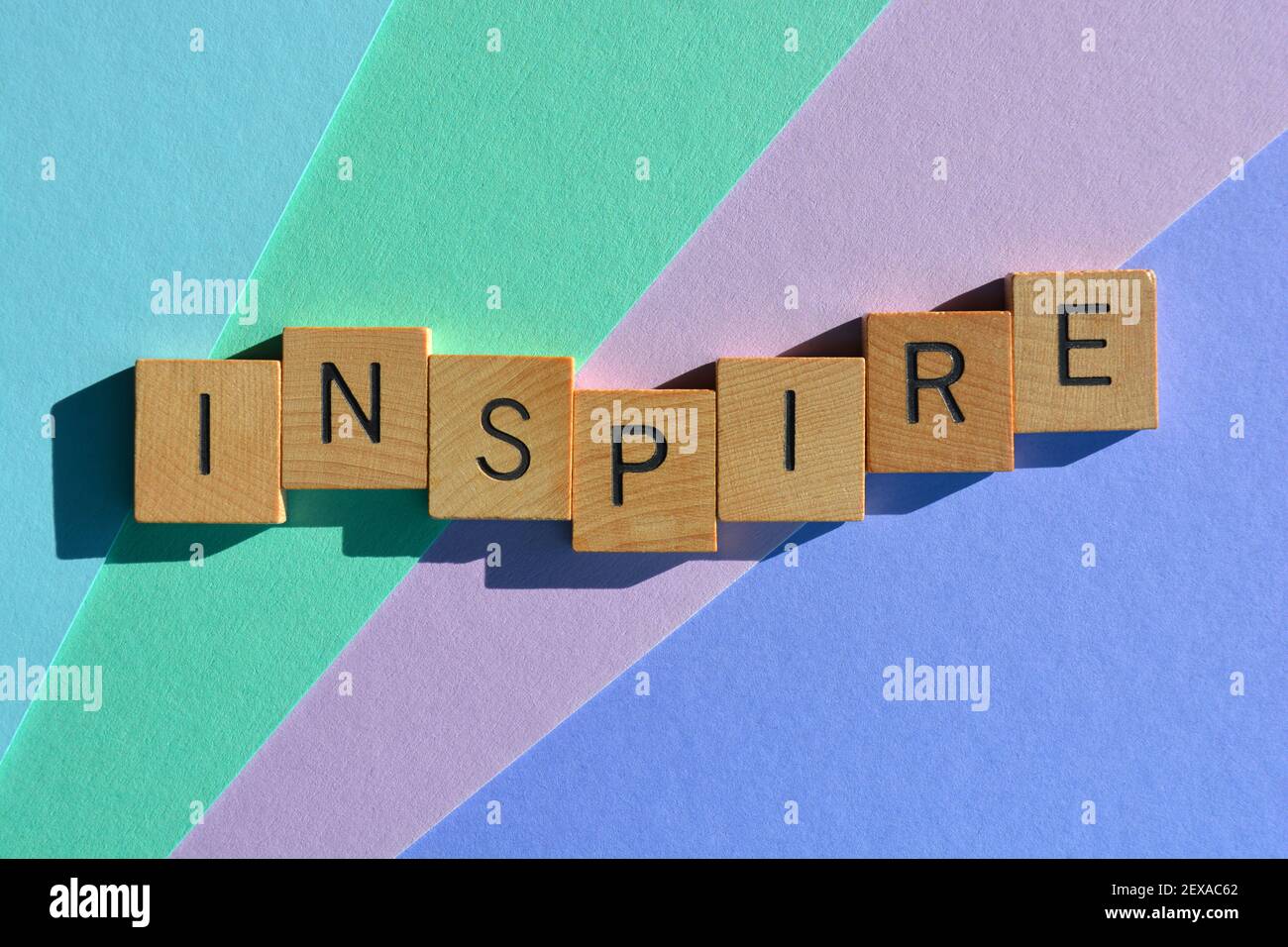 Inspire, word in wooden alphabet letters isolated on colourful ...