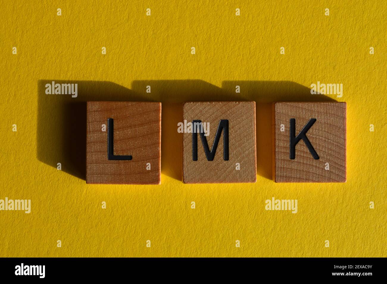 LMK, acronym for Let Me Know, in wooden alphabet letters isolated on ...