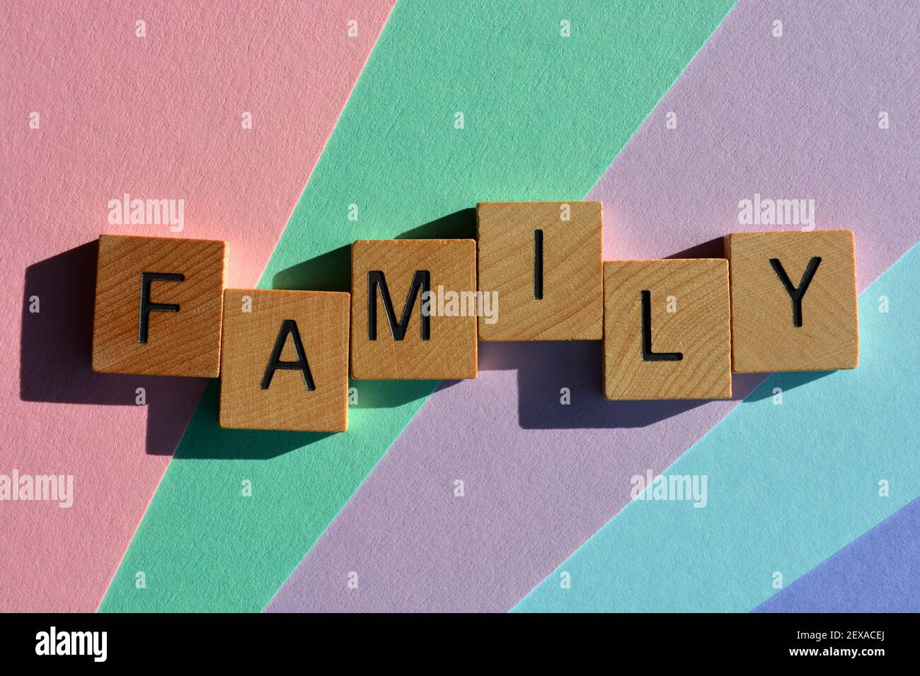 Family, word in wooden alphabet letters isolated on colourful ...