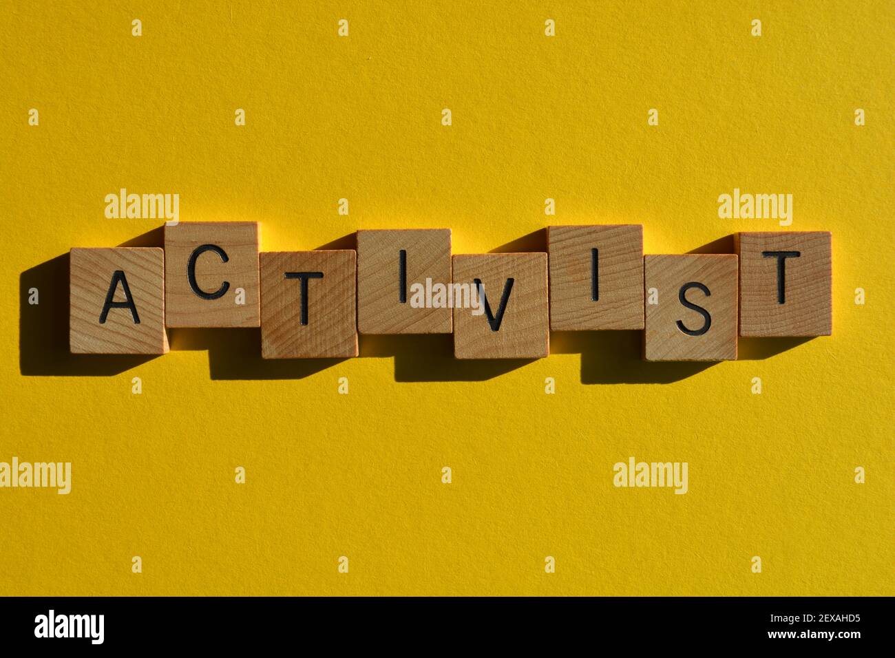 Activists, word in wooden alphabet letters isolated on bright yellow ...