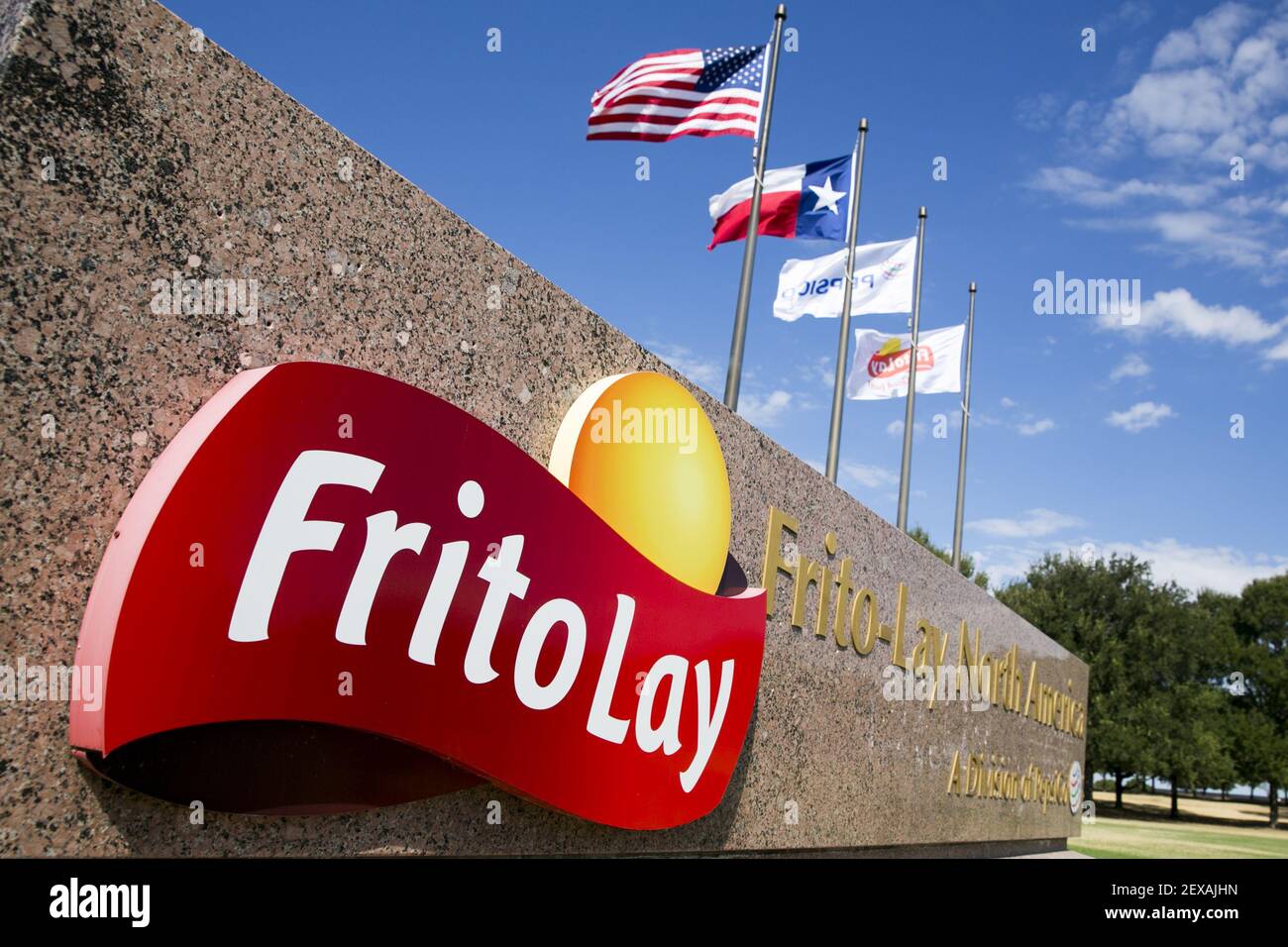 A logo sign outside of the headquarters of Frito-Lay, Inc., a ...