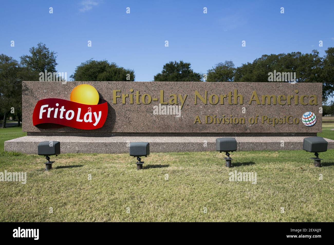 A logo sign outside of the headquarters of Frito-Lay, Inc., a ...