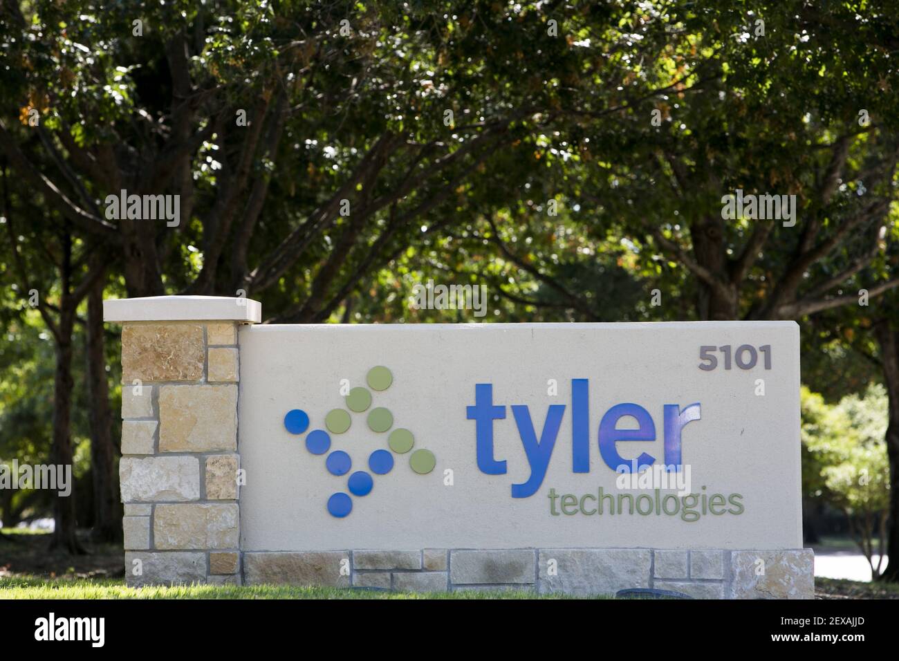 A logo sign outside of the headquarters of Tyler Technologies, Inc., in ...