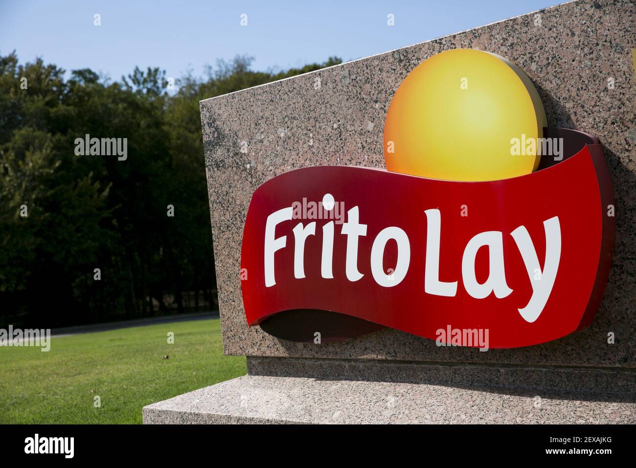 A logo sign outside of the headquarters of Frito-Lay, Inc., a ...