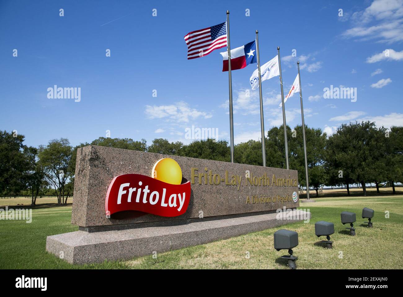 A logo sign outside of the headquarters of Frito-Lay, Inc., a ...