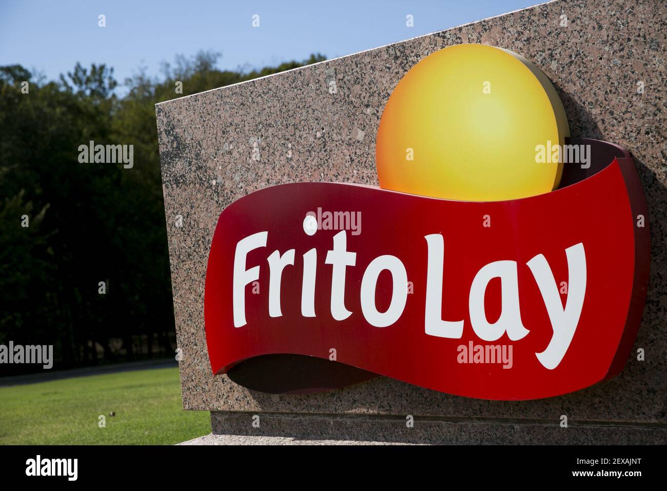 A logo sign outside of the headquarters of Frito-Lay, Inc., a ...