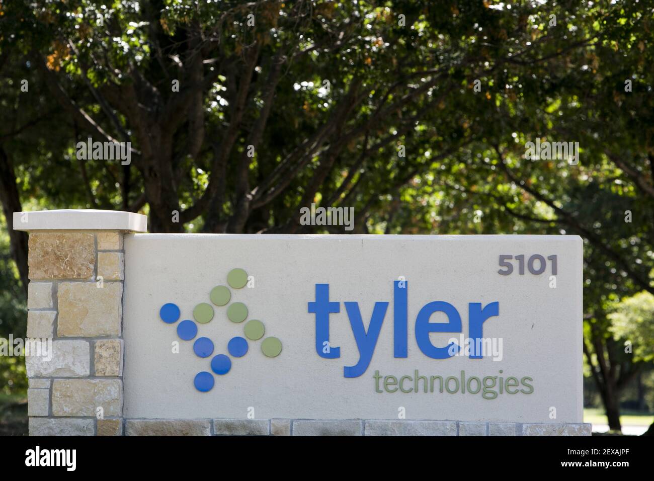 A logo sign outside of the headquarters of Tyler Technologies, Inc., in ...