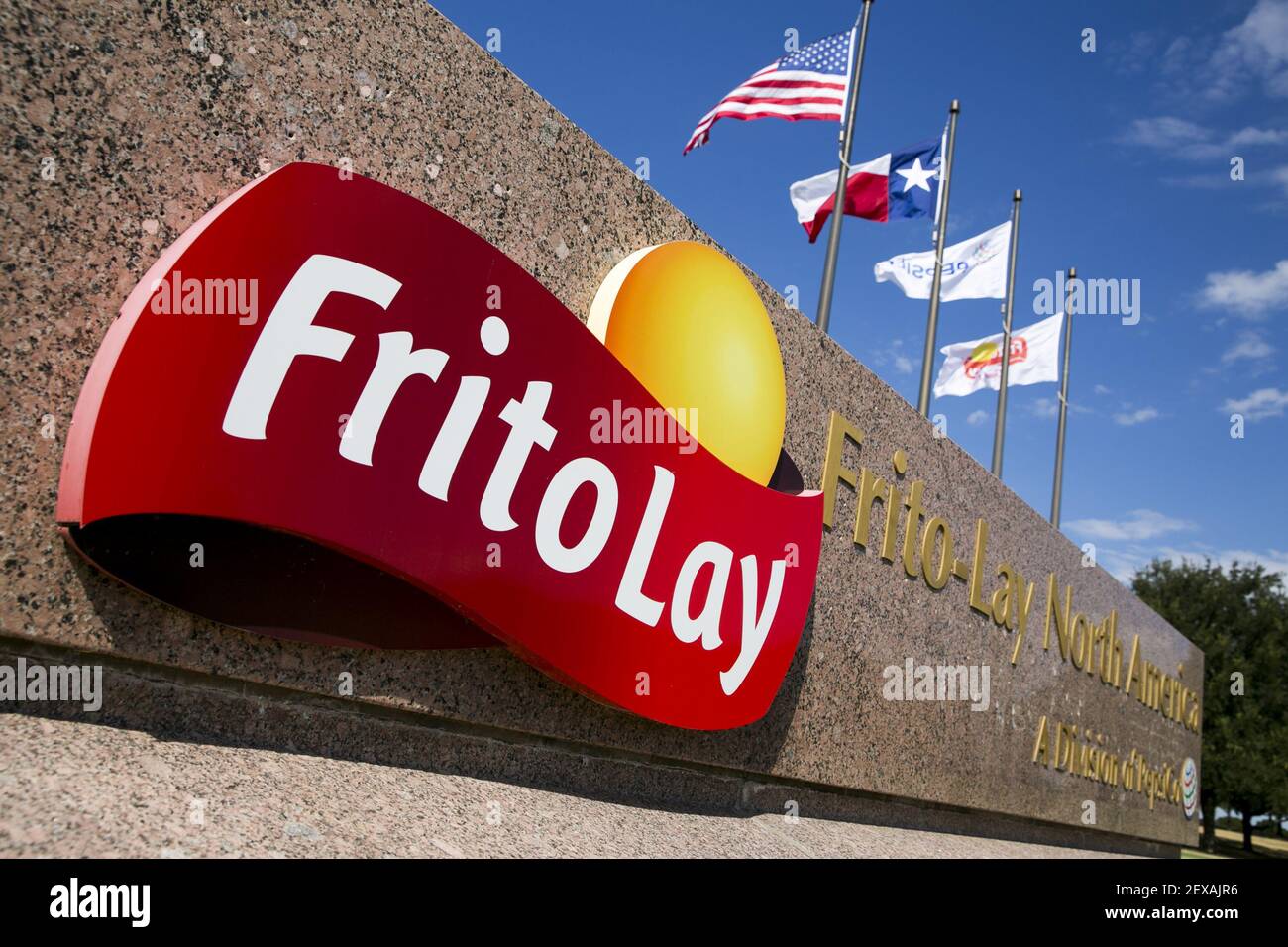 A logo sign outside of the headquarters of Frito-Lay, Inc., a ...