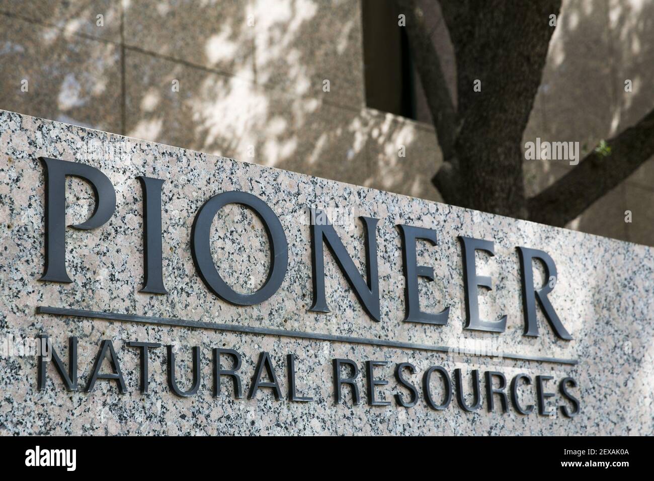 A logo sign outside of the headquarters of the Pioneer Natural ...