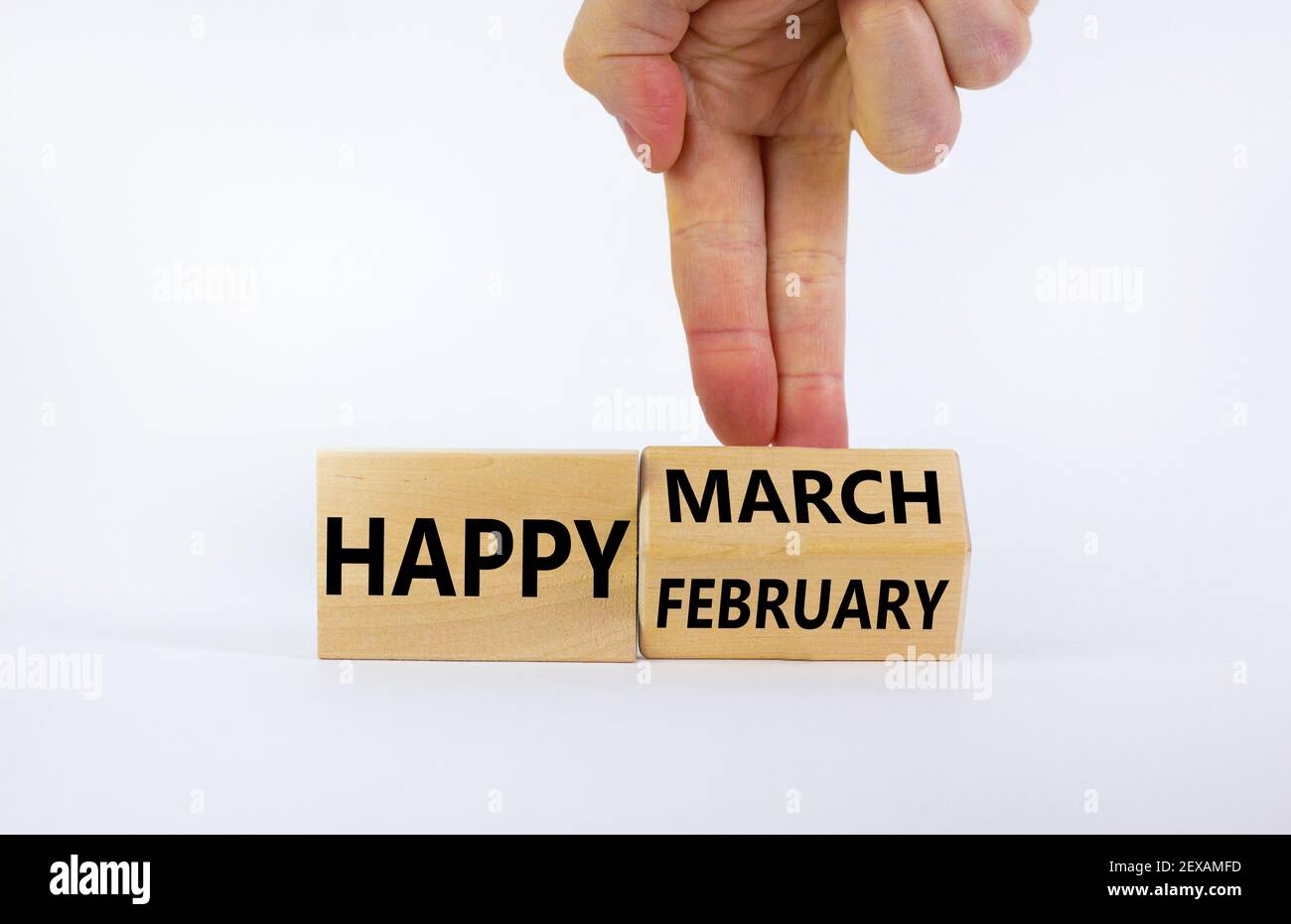Symbol for the change from February to March. Businessman turns wooden ...