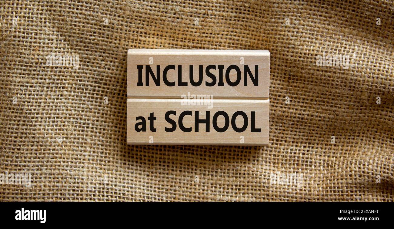 Inclusion at school symbol. Wooden blocks with words 'Inclusion at ...