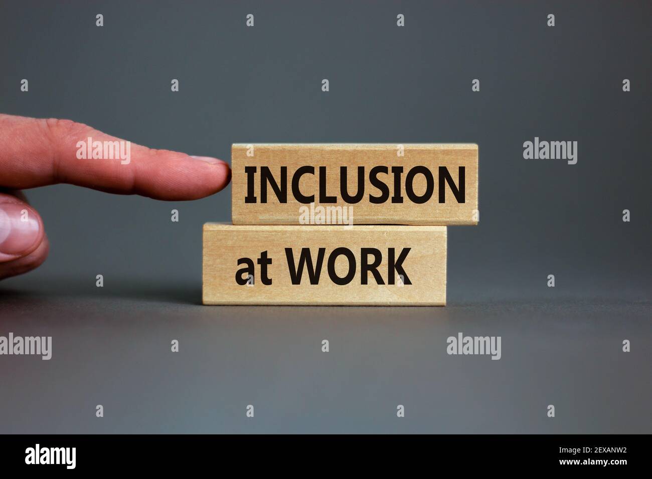 Inclusion at work symbol. Wooden blocks with words 'Inclusion at work ...
