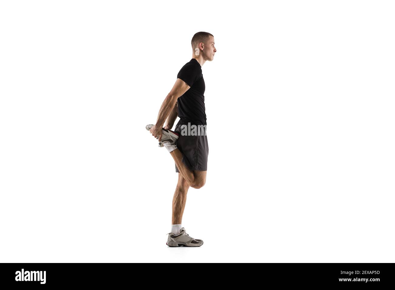 Stretching. Young caucasian male model in action, motion isolated on ...