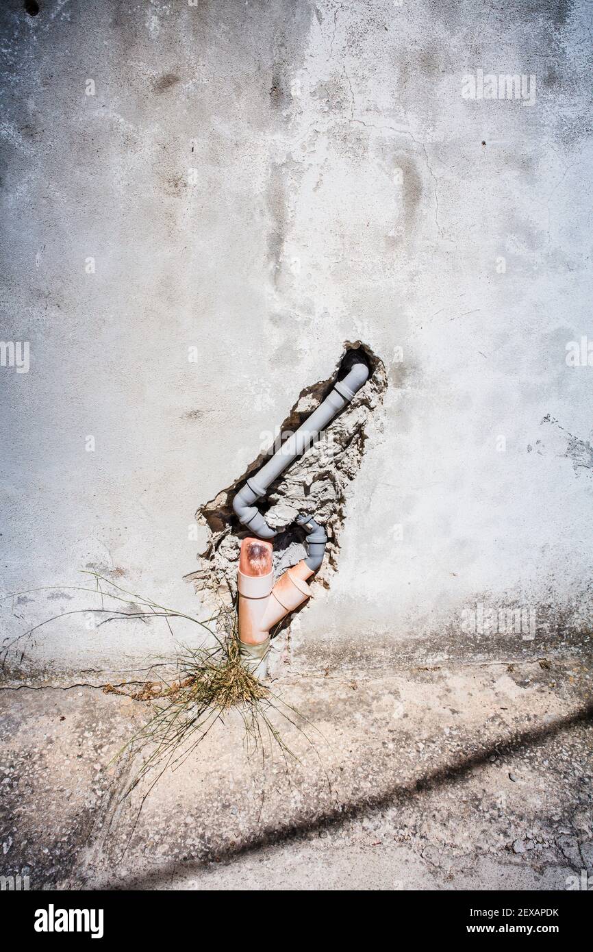 Old rundown building with exposed pipe Stock Photo - Alamy