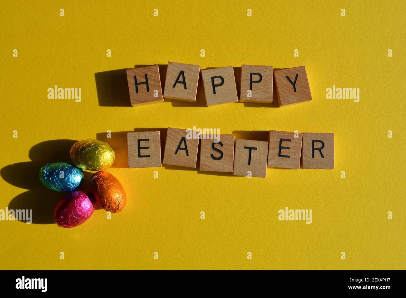 Happy Easter, words in wooden alphabet letters and foil wrapped ...