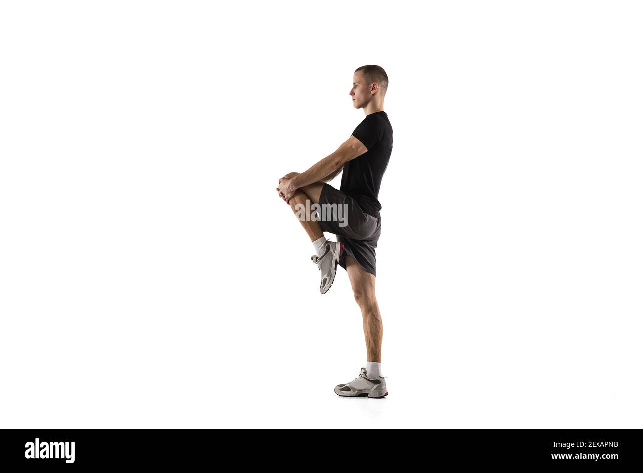 Stretching. Young caucasian male model in action, motion isolated on ...