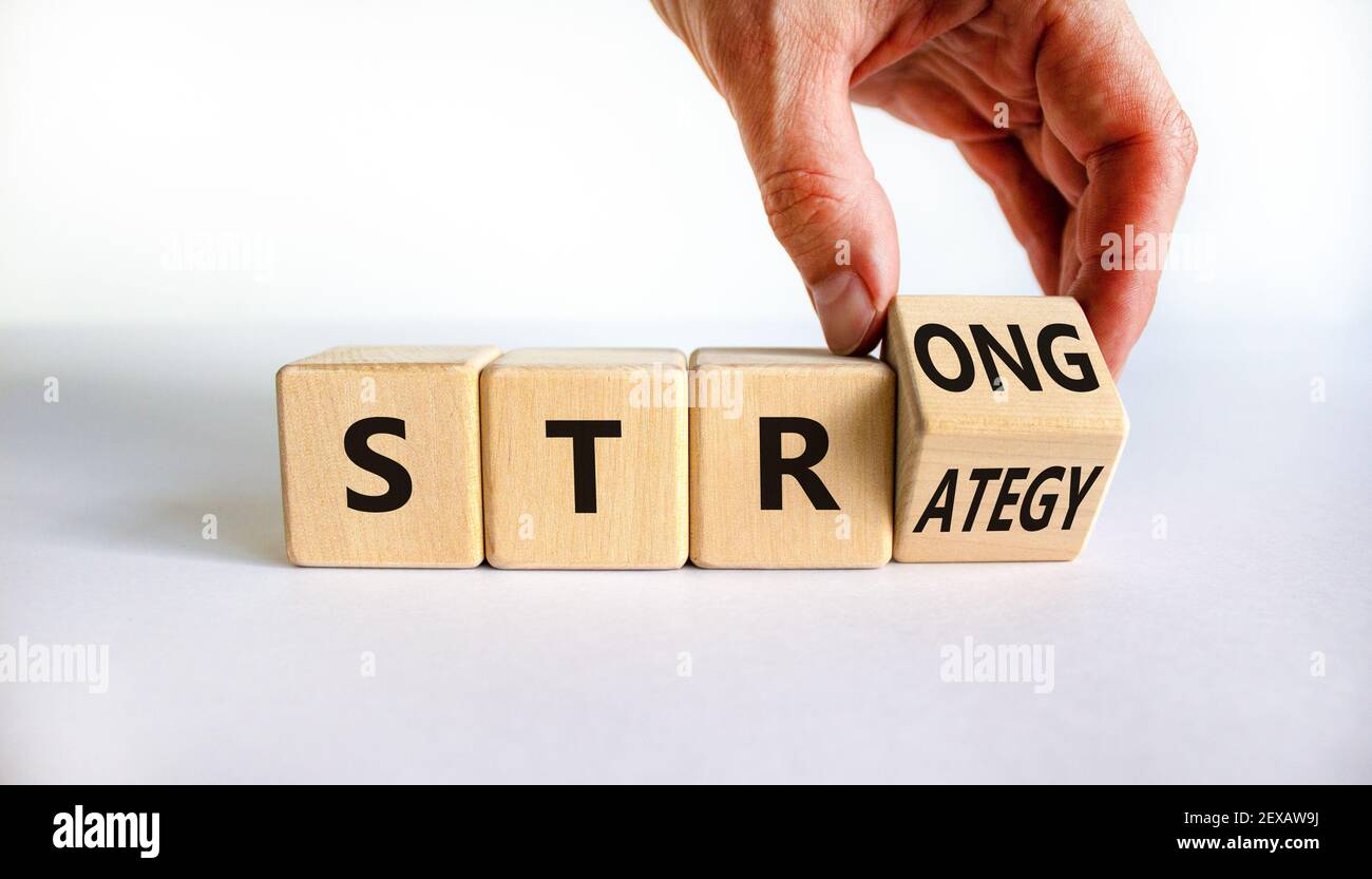 Strong strategy symbol. Businessman turns a wooden cube with words ...
