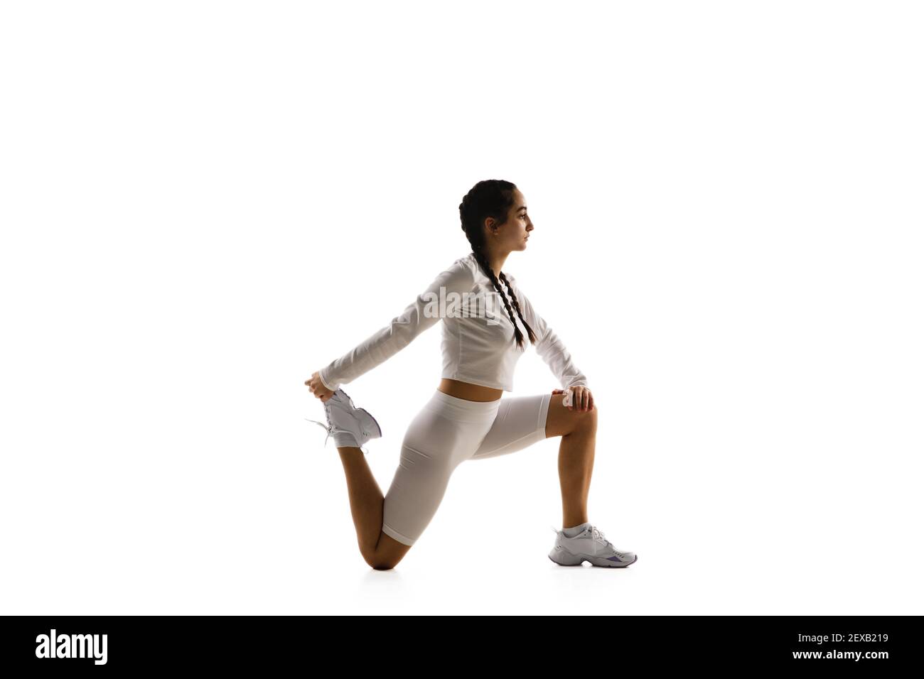 Stretching. Young caucasian female model in action, motion isolated on ...