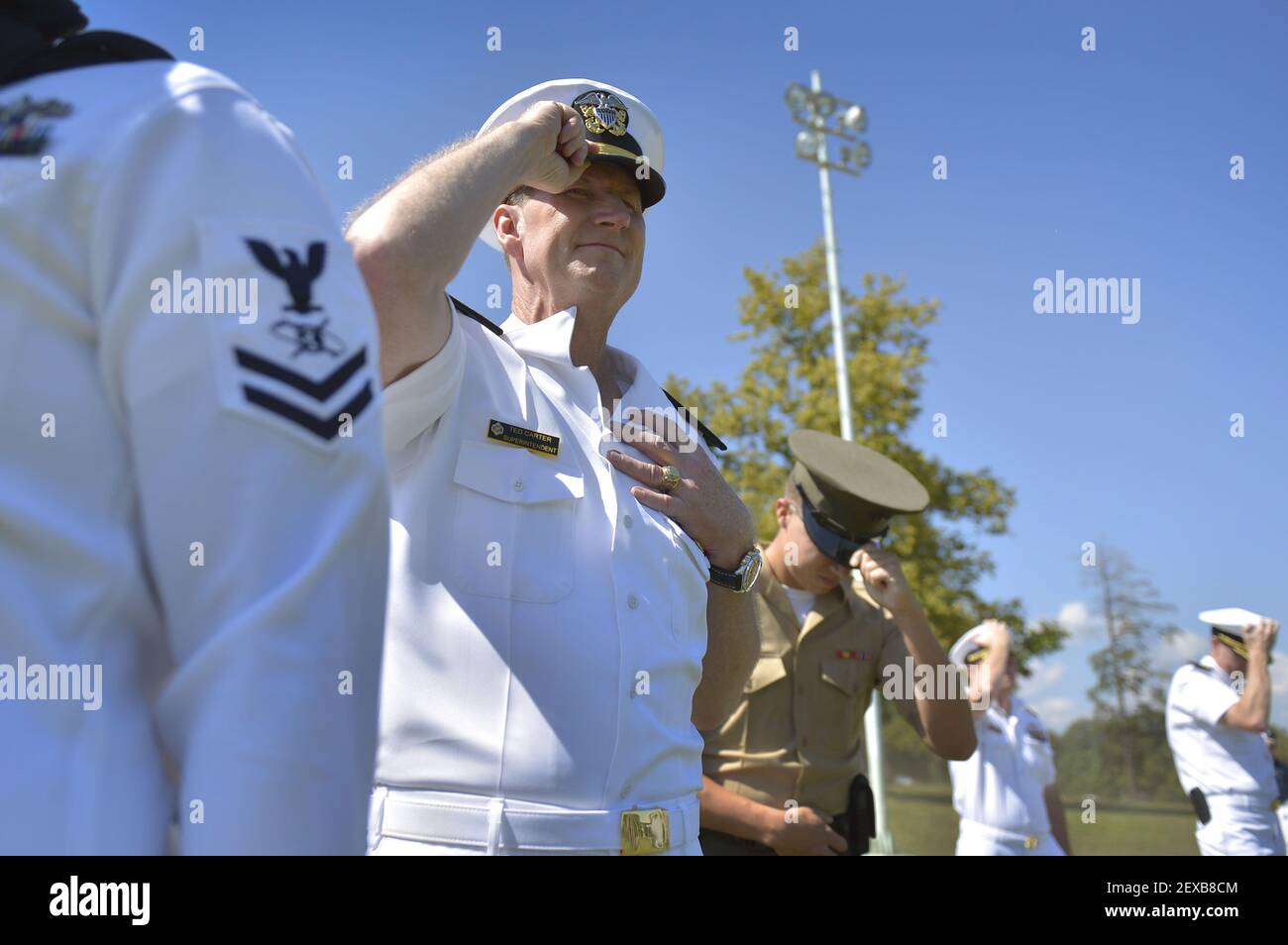 U.S. Naval Academy Superintendent Vice Adm. Ted Carter hangs onto his ...