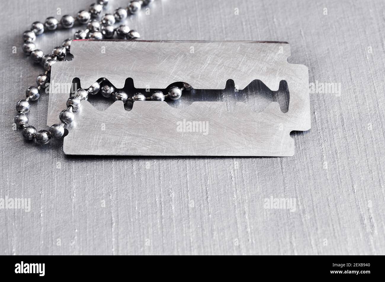 Brushed silver metal with razor blade Stock Photo - Alamy