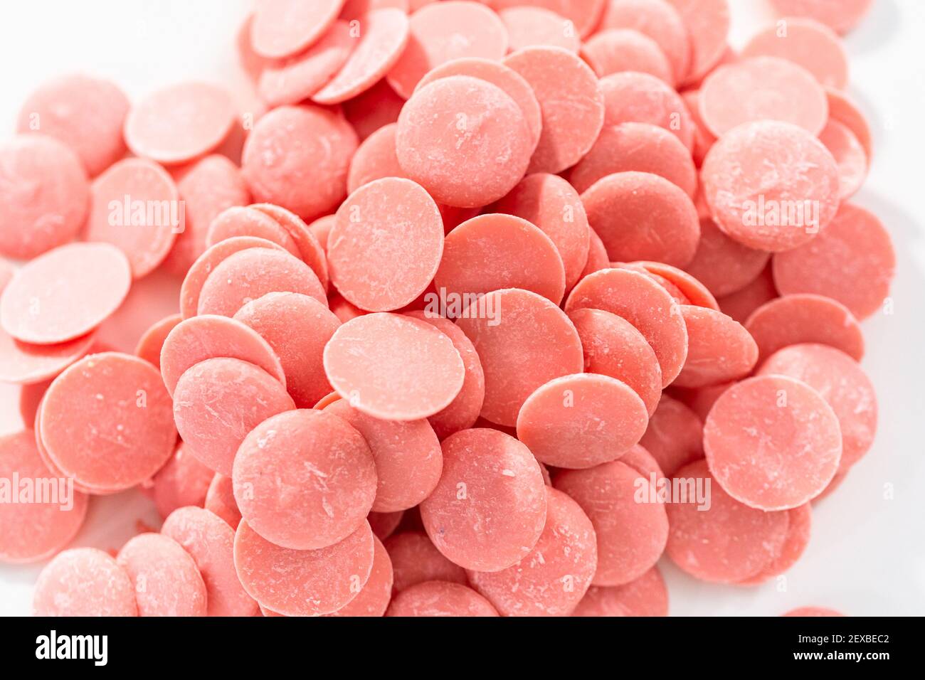 Pink round chocolate chips for melting chocolate shapes on a white ...