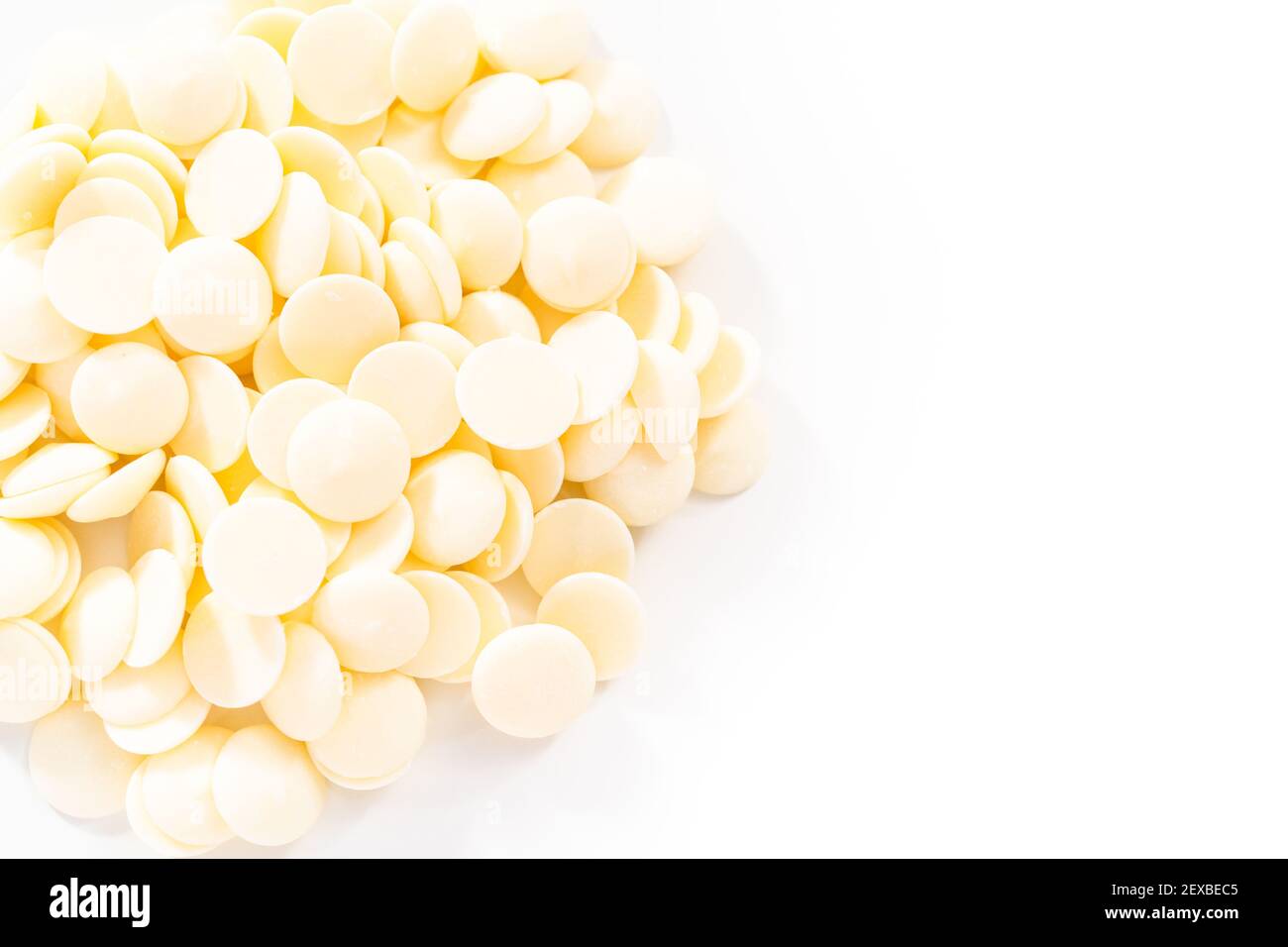 White round chocolate chips for melting chocolate shapes on a white ...