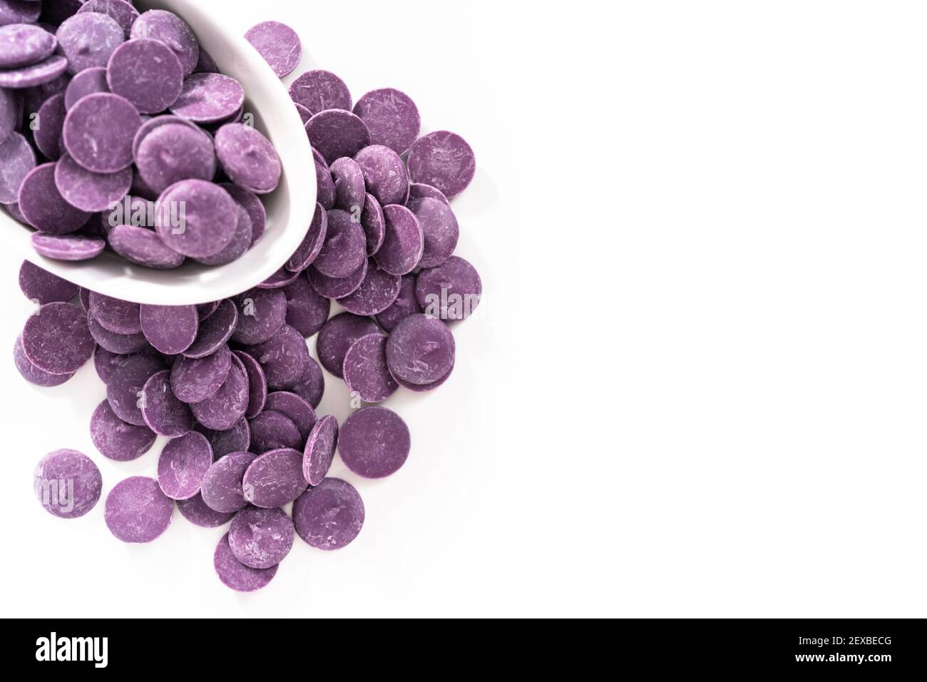 Purple round chocolate chips for melting chocolate shapes on a white ...