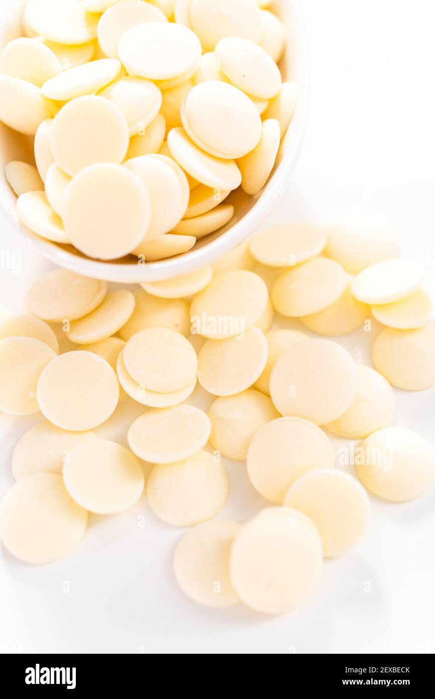 White round chocolate chips for melting chocolate shapes on a white ...