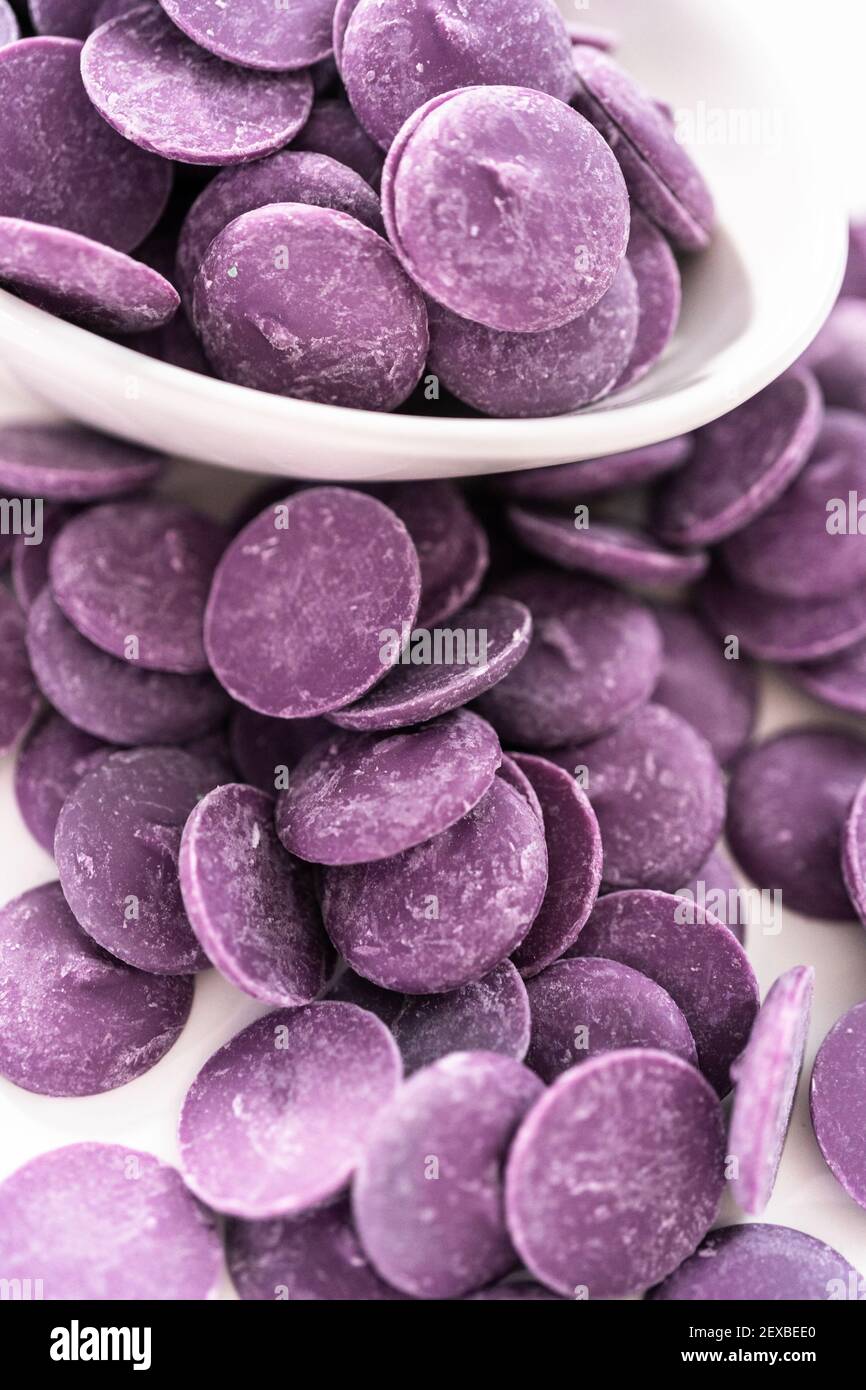 Purple round chocolate chips for melting chocolate shapes on a white ...