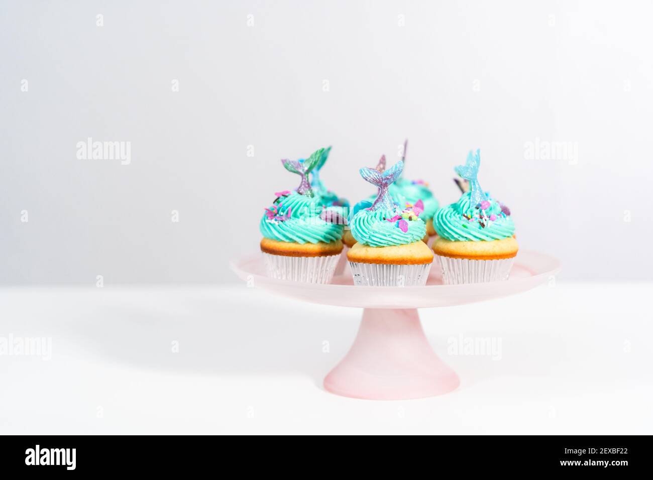 Gourmet mermaid cupcakes topped with blue buttercream frosting and ...