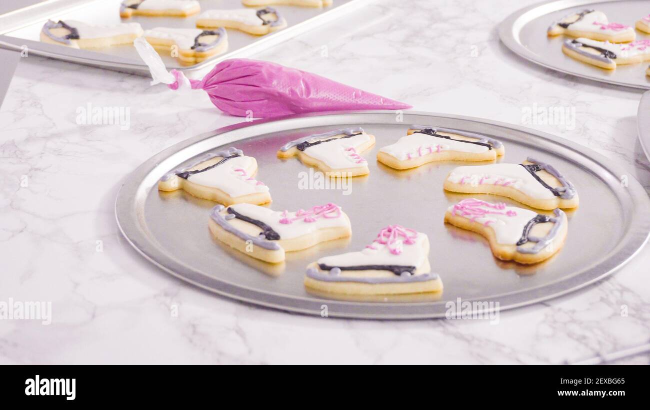 Icing figure skate shaped sugar cookies with royal icing Stock Photo ...