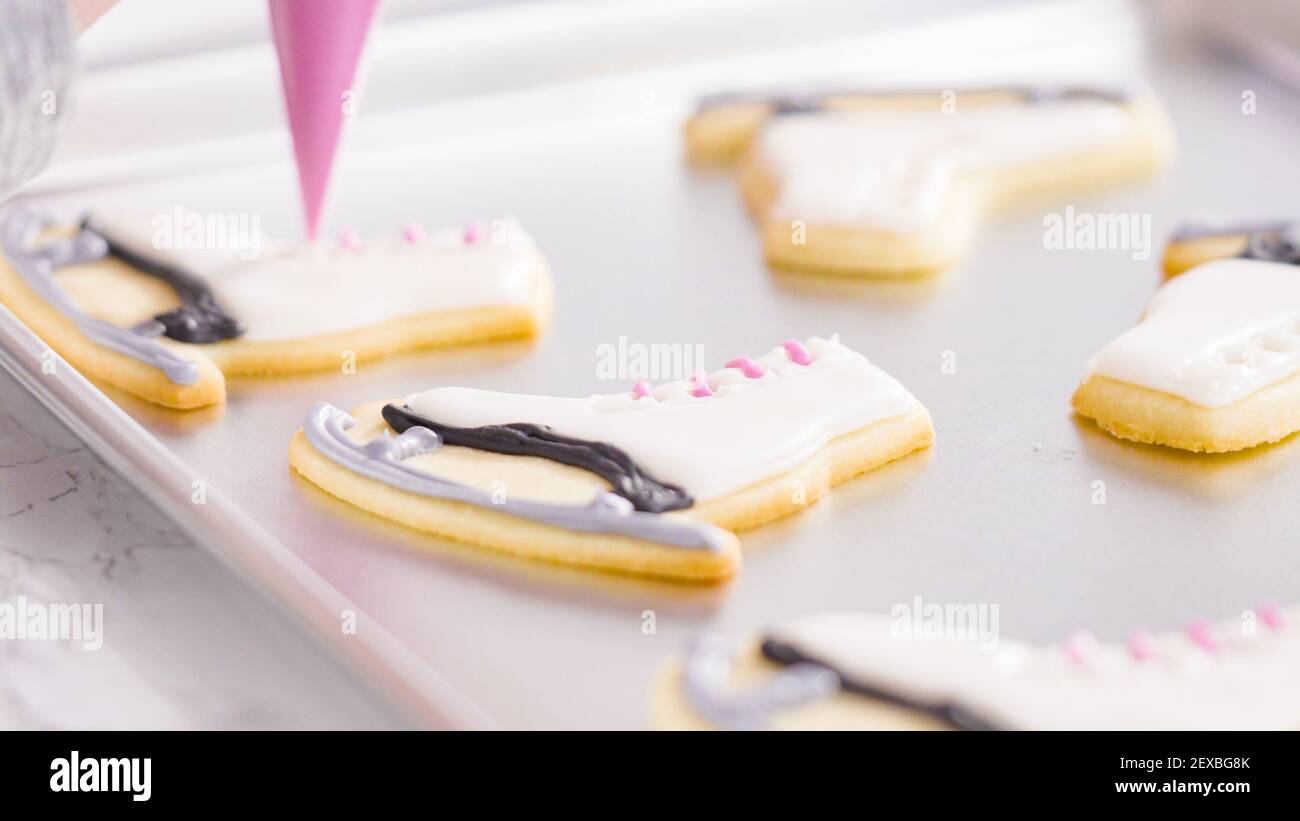 Icing figure skate shaped sugar cookies with royal icing Stock Photo ...