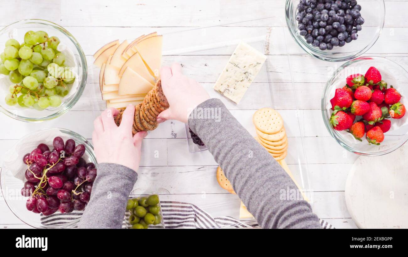 Flat lay. Step by step. Arranging cheese platter with fresh fruits ...