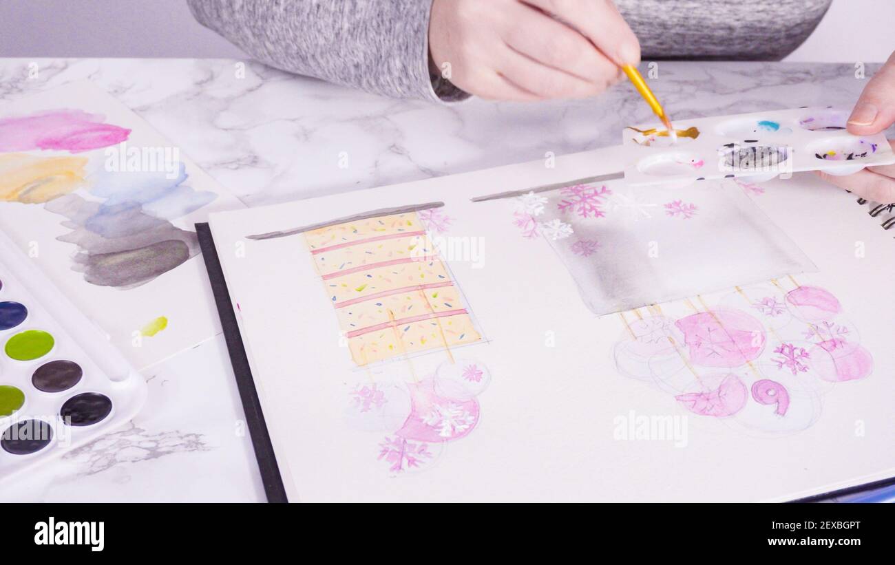 Baker is drawing the design of a birthday cake with watercolors Stock ...
