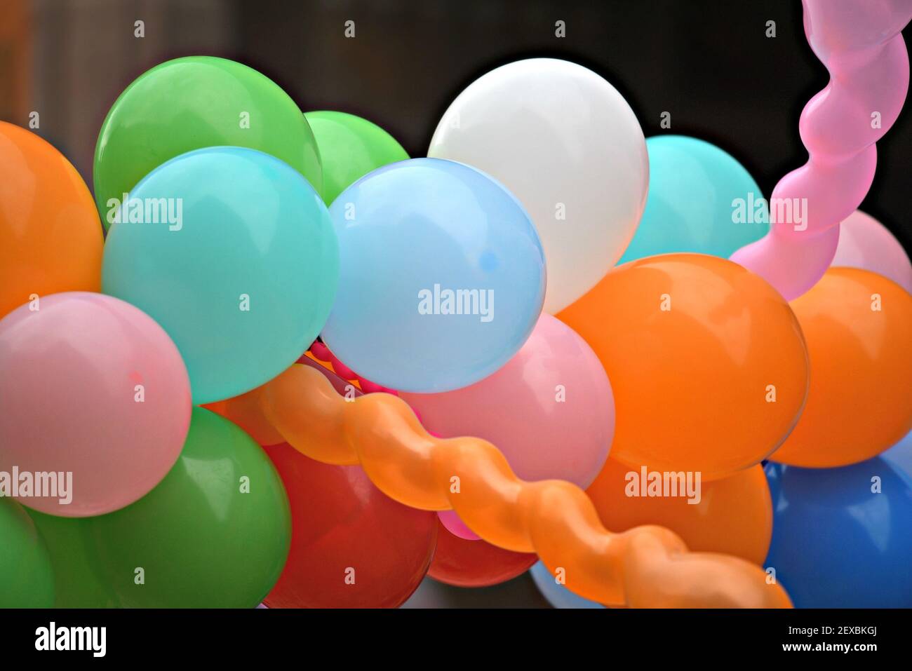Colorful balloons at the local parade Día de los Locos in San Miguel de ...